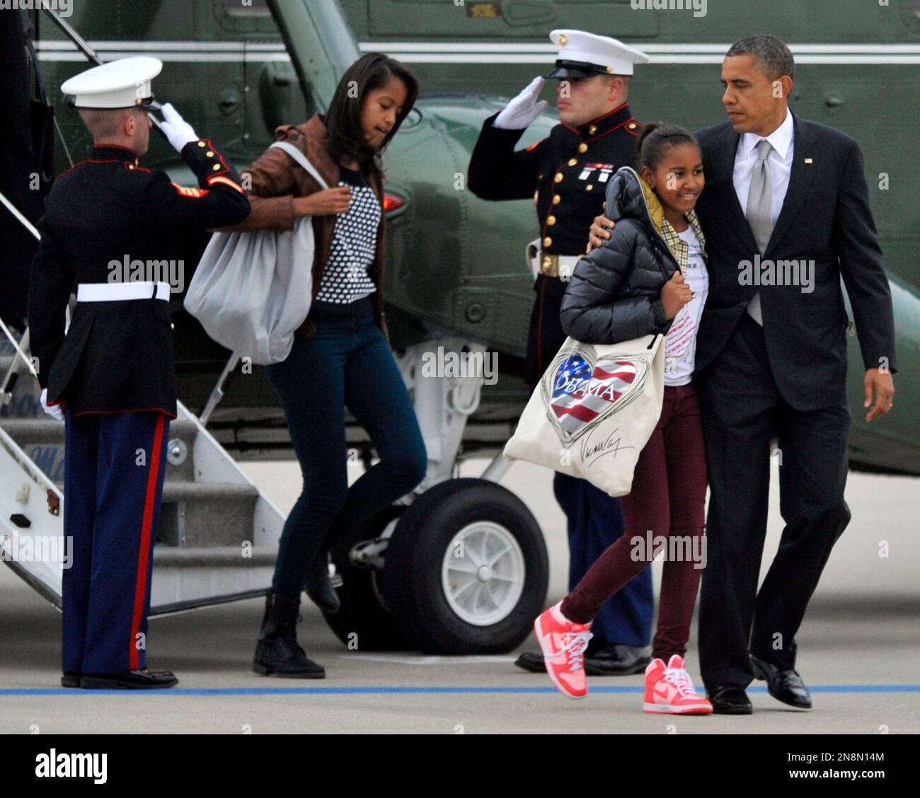 President Barack Obama walks off Marine One with daughters Sasha right ...
