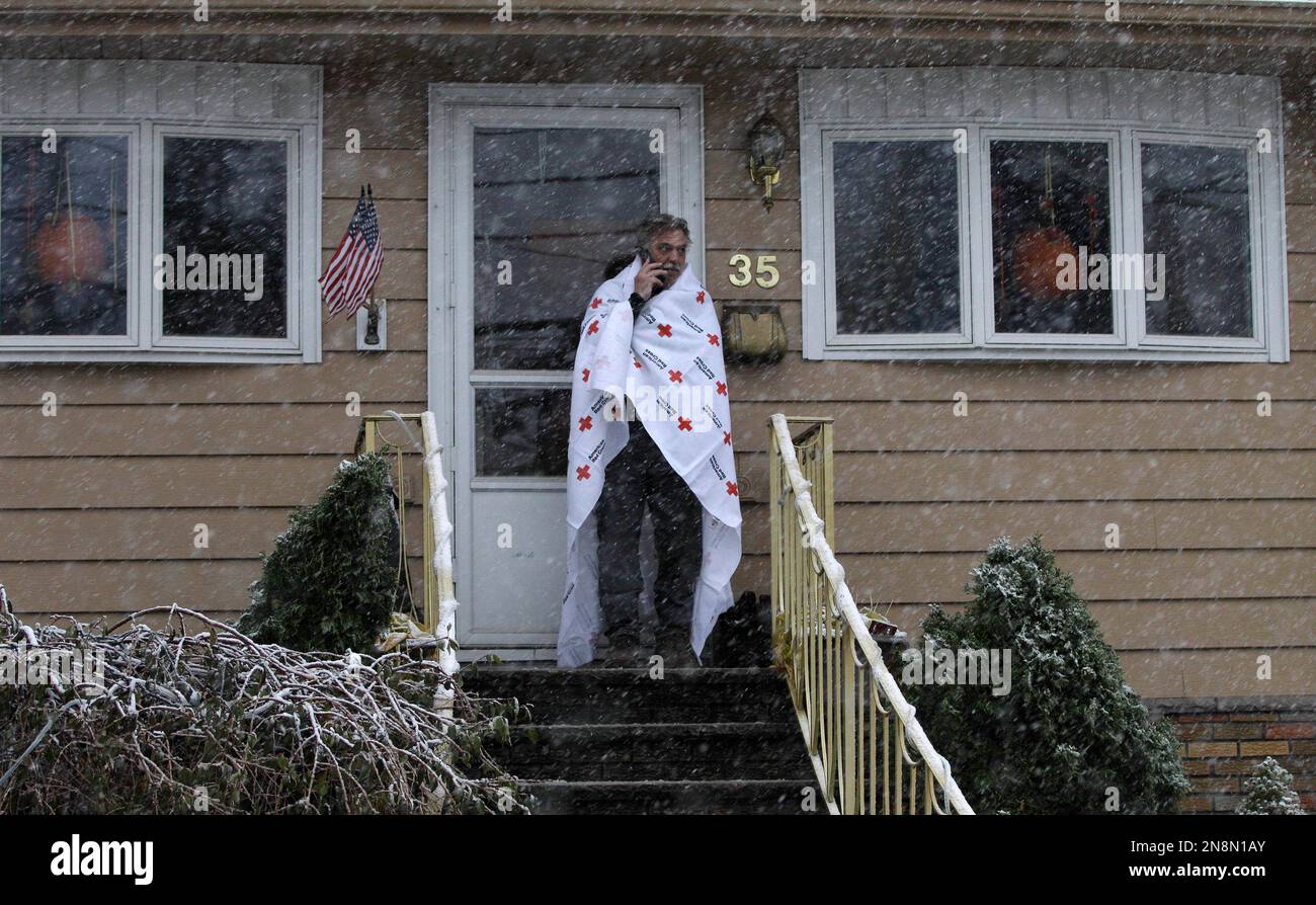 Ben Colontonio talks on his cell phone wrapped in a blanket donated by ...