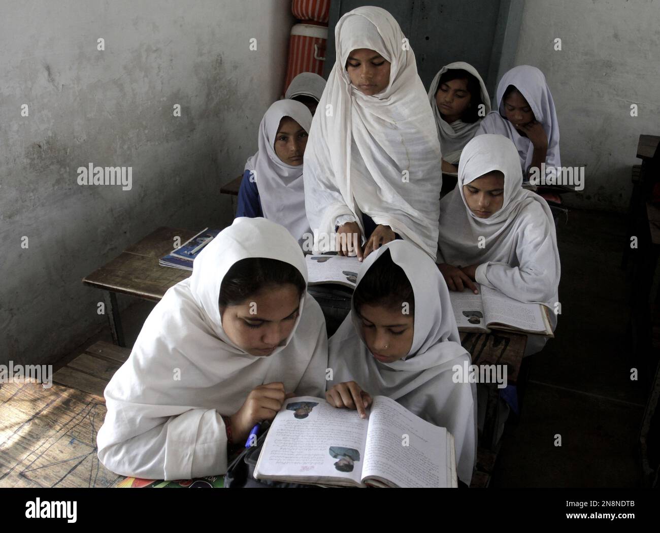 Pakistani students attend class at a school on the outskirts of Lahore ...
