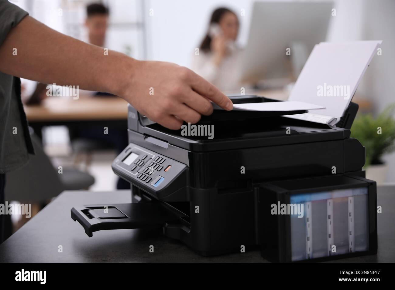 Employee using modern printer in office, closeup Stock Photo - Alamy