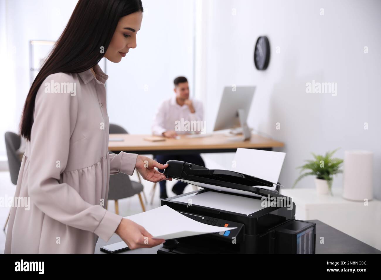 Employee using new modern printer in office Stock Photo - Alamy