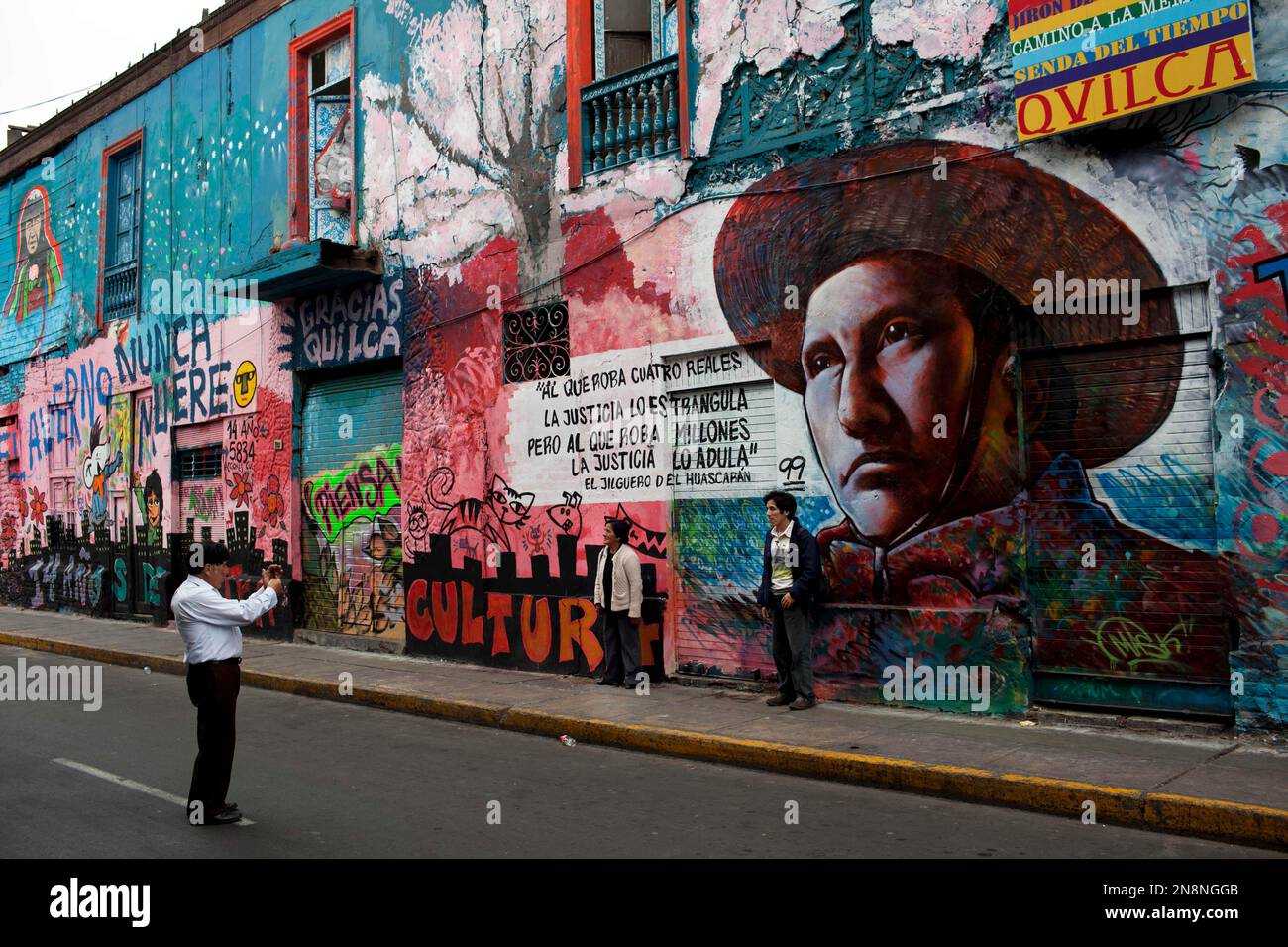 People is pictured in front of a graffiti depicting the Peruvian late ...