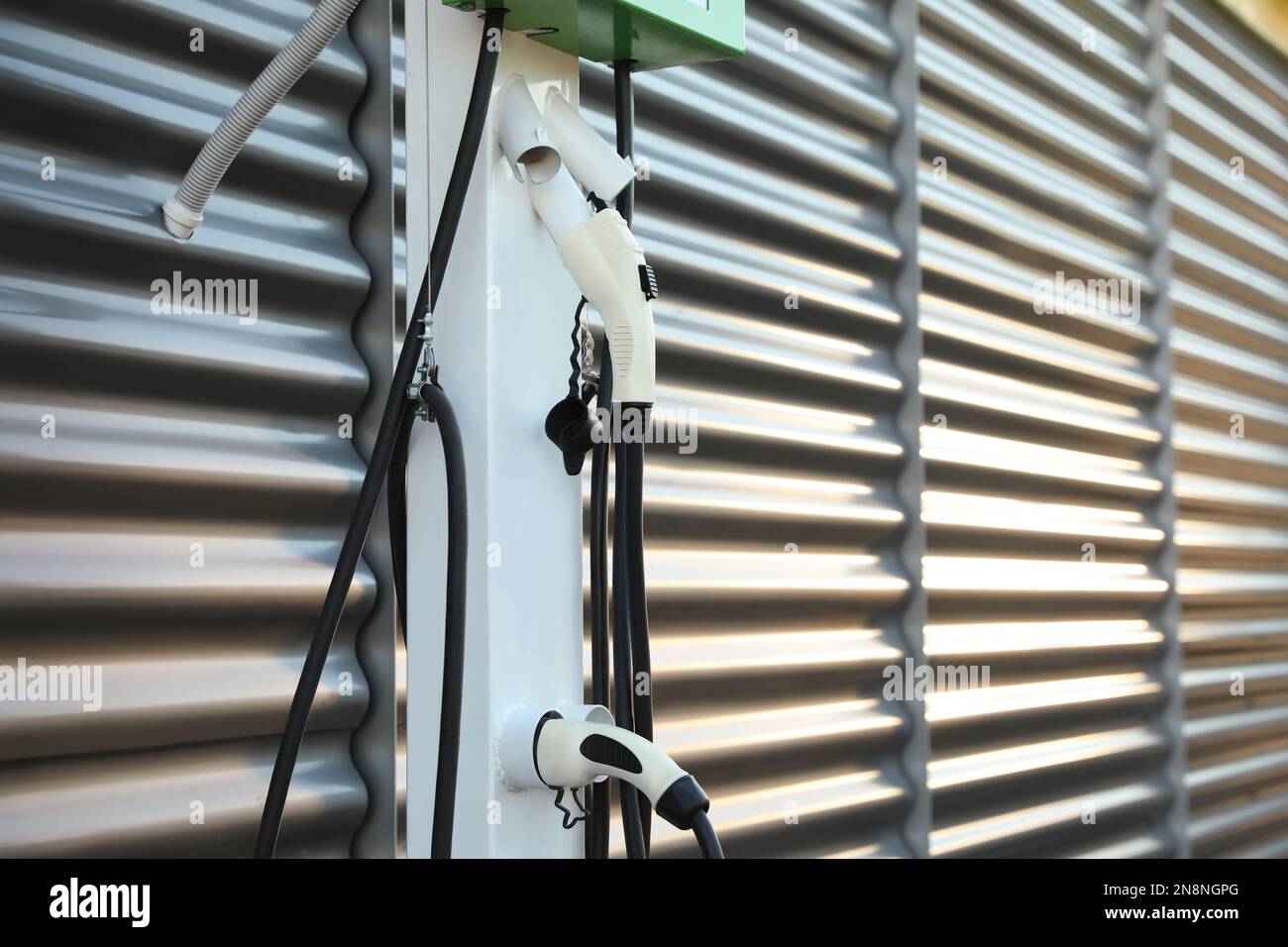 Electric vehicle charging station outdoors, space for text. Modern ...