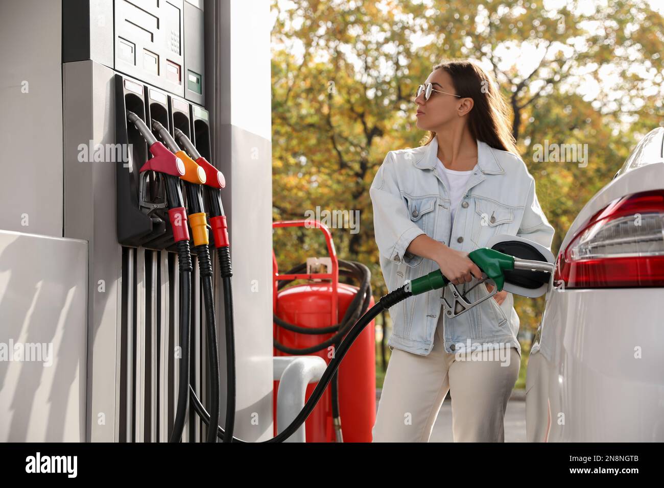 Woman refueling car at self service gas station Stock Photo - Alamy