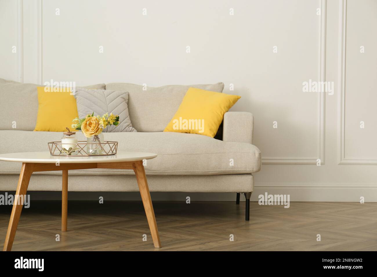 Stylish beige sofa in living room interior Stock Photo - Alamy