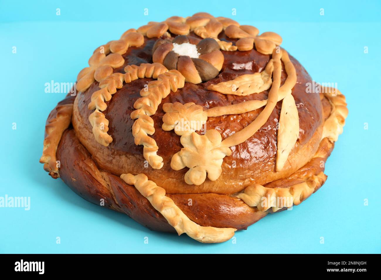 Fresh korovai on light blue background, closeup. Ukrainian bread and ...