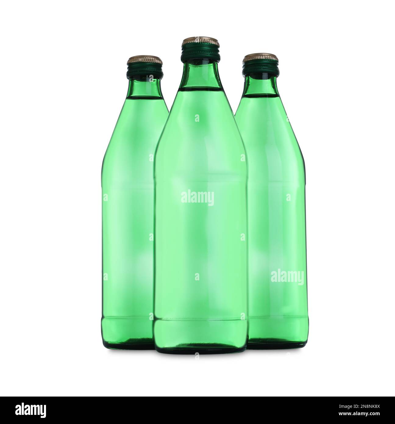 Glass bottles with water on table against white background Stock Photo ...
