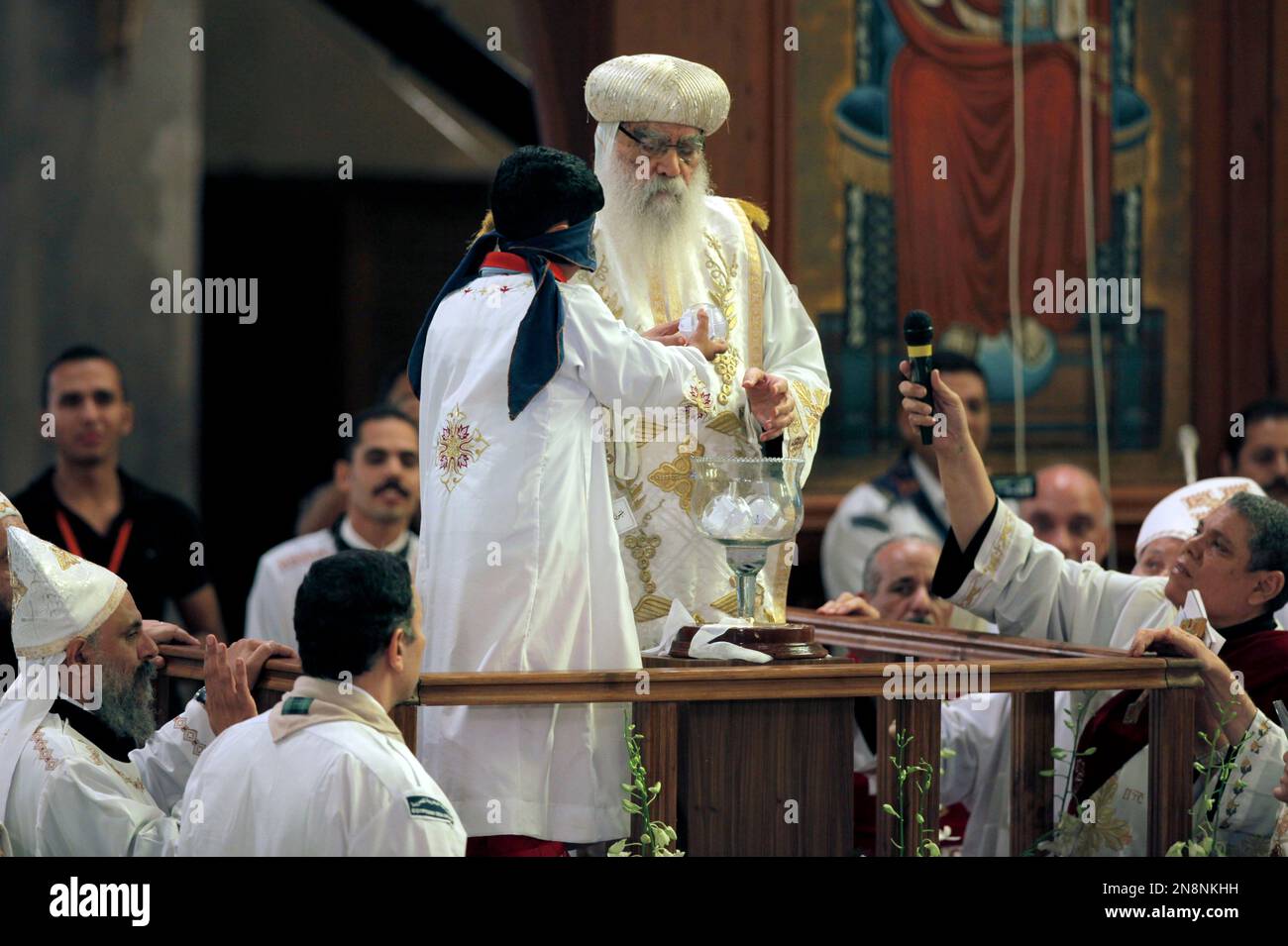 A blindfolded boy draws the name of the next pope from a crystal ...