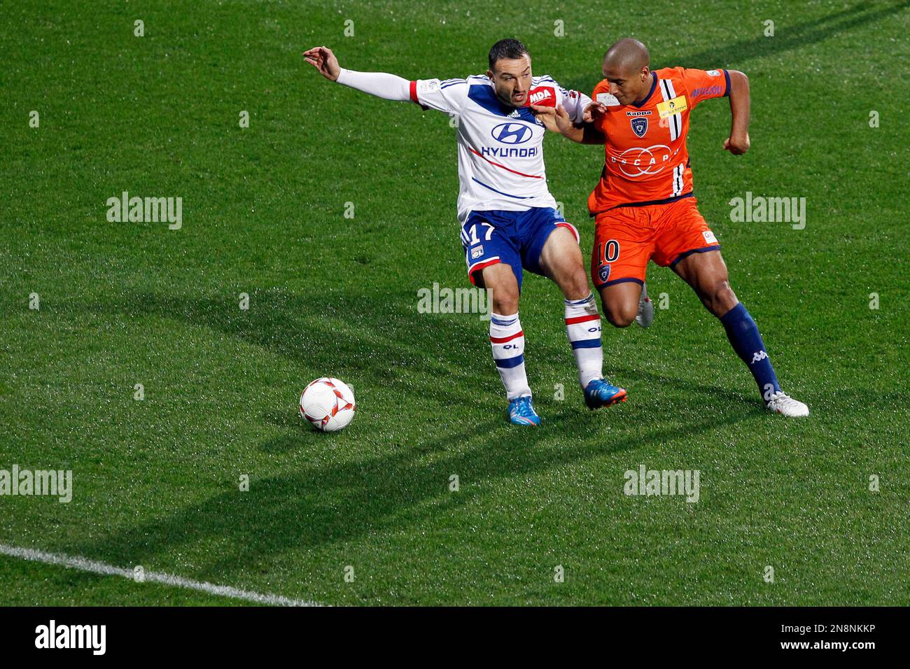 Lyon's Steed Malbranque, left, challenges for the ball with Bastia's ...