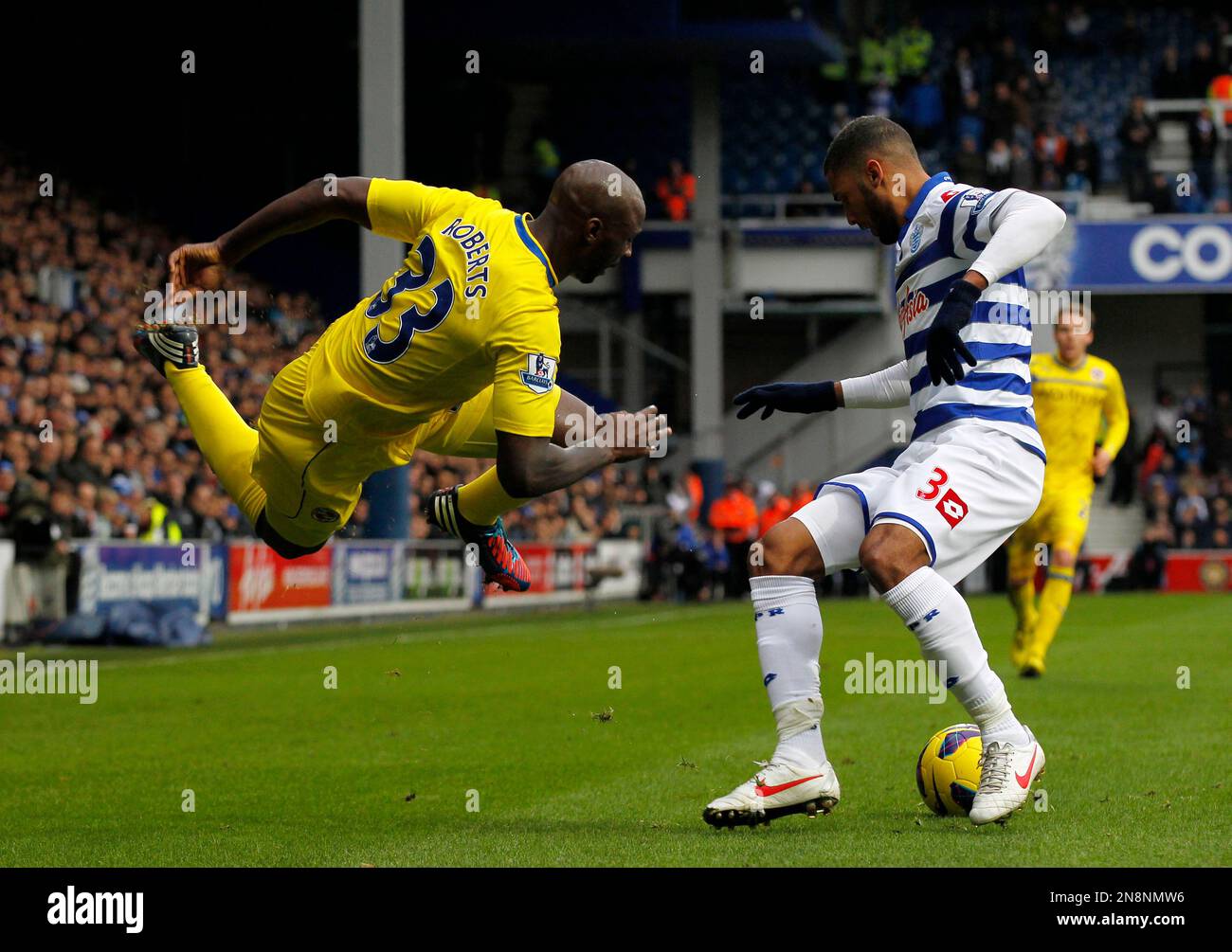 Reading's Jason Roberts, left, is tackled by Queens Park Rangers ...