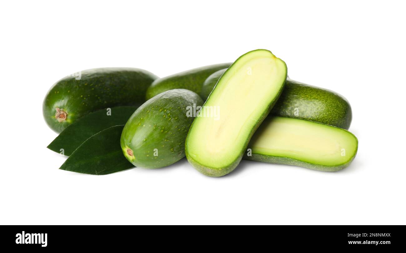 Cut and whole seedless avocados with leaves isolated on white Stock ...