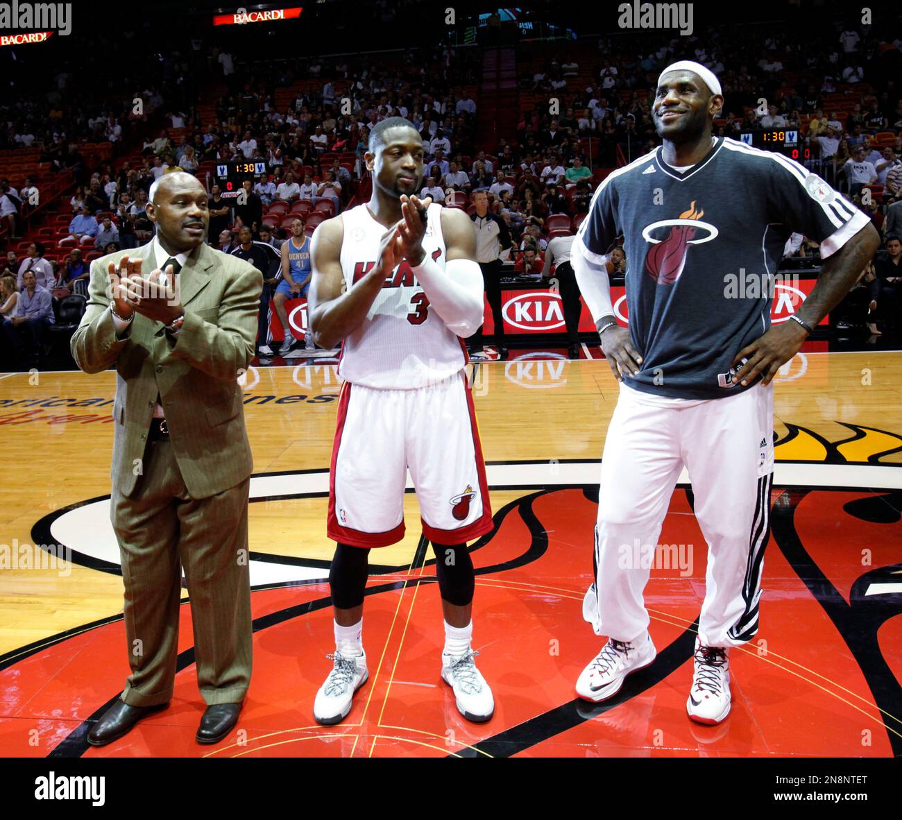 Miami Heat forward LeBron James, right, smiles as he, former Heat ...
