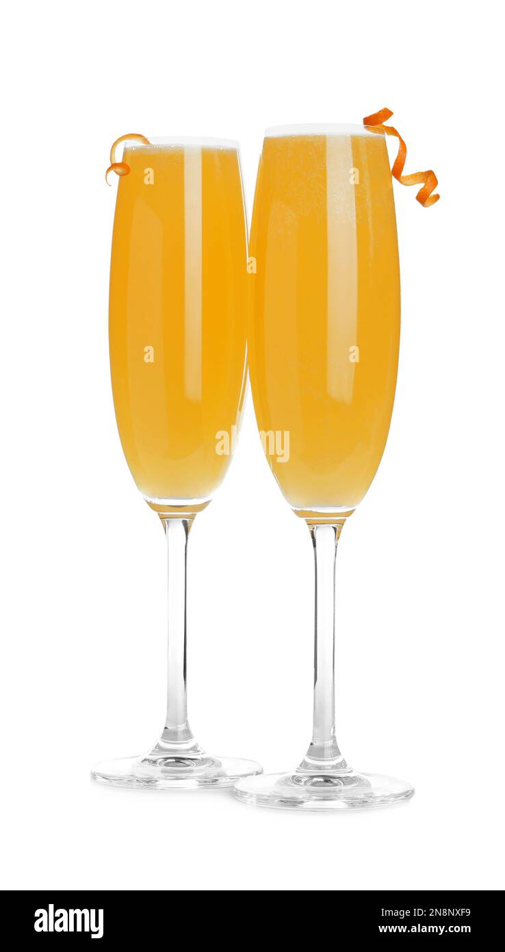 Fresh alcoholic Mimosa cocktails decorated with orange peels on white ...