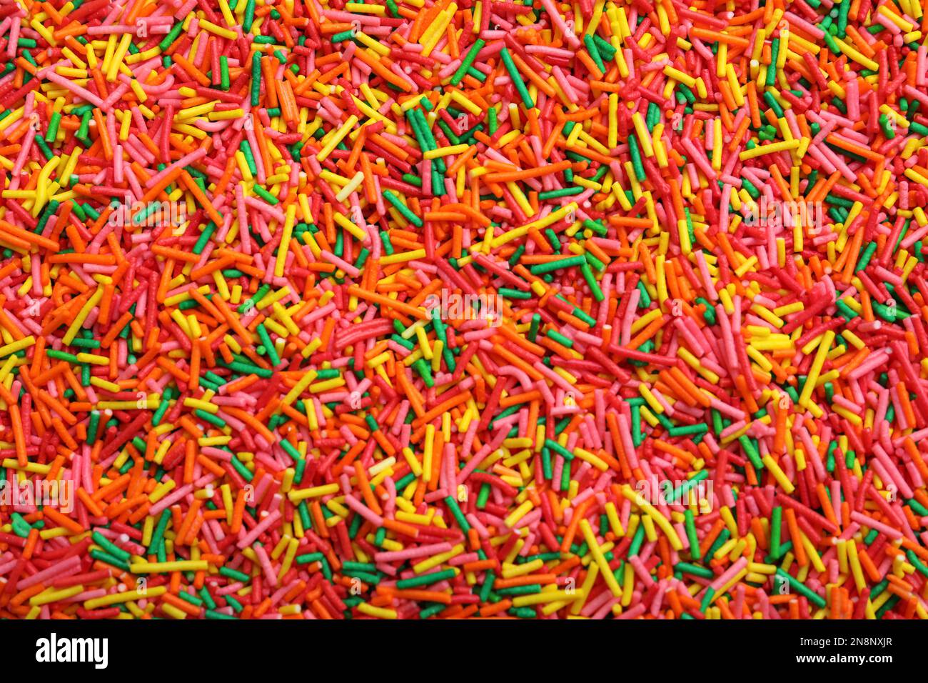 Bright colorful sprinkles as background, top view. Confectionery decor ...
