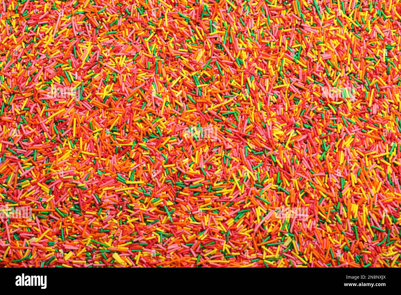 Bright colorful sprinkles as background, top view. Confectionery decor ...