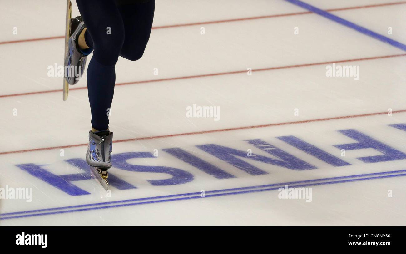 A speedskater crosses the finish line in the 5000 meter event of the U ...
