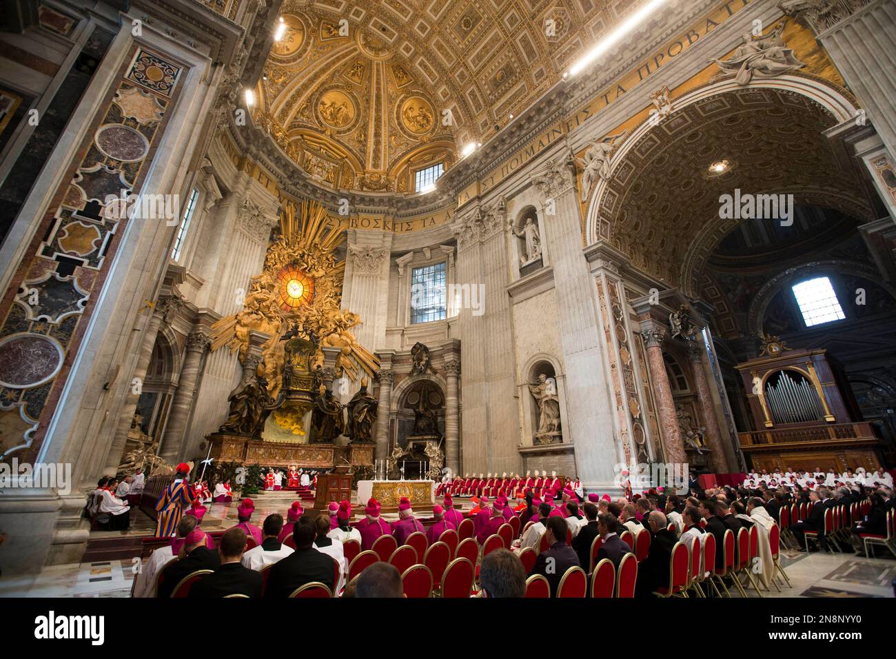 Pope Benedict XVI, figure in red sitting beneath St. Peter's throne ...