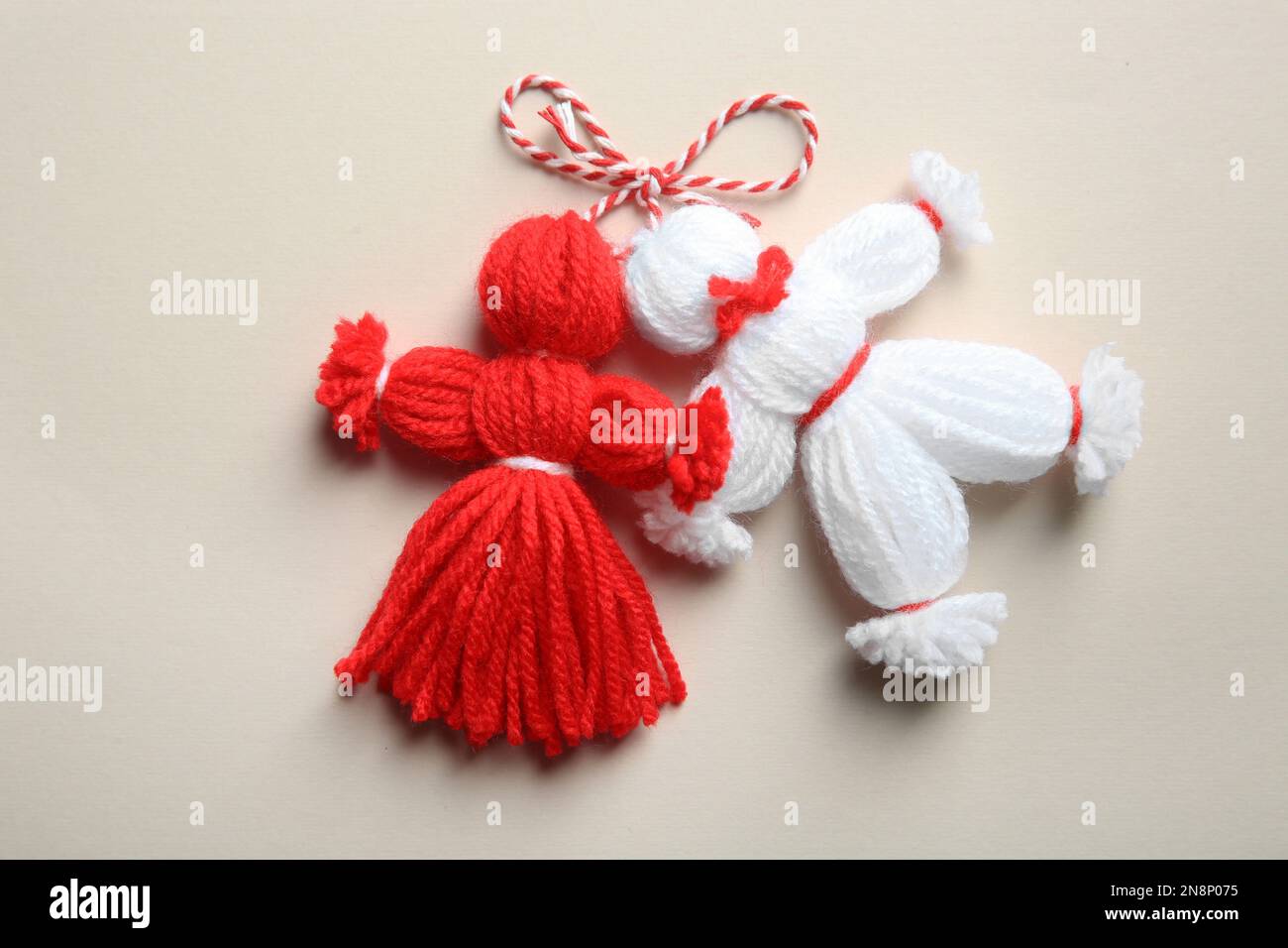 Traditional martisor shaped as man and woman on light background, top ...
