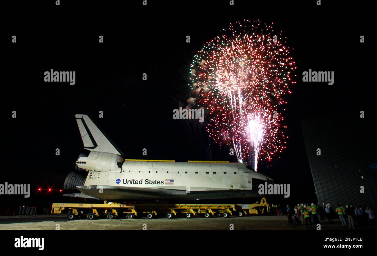 Fireworks burst in the air over space shuttle Atlantis after it arrived ...