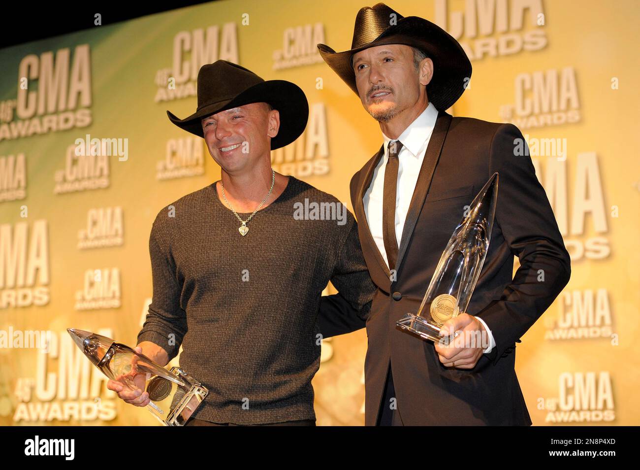 Kenny Chesney, left, and Tim McGraw pose backstage with their awards ...