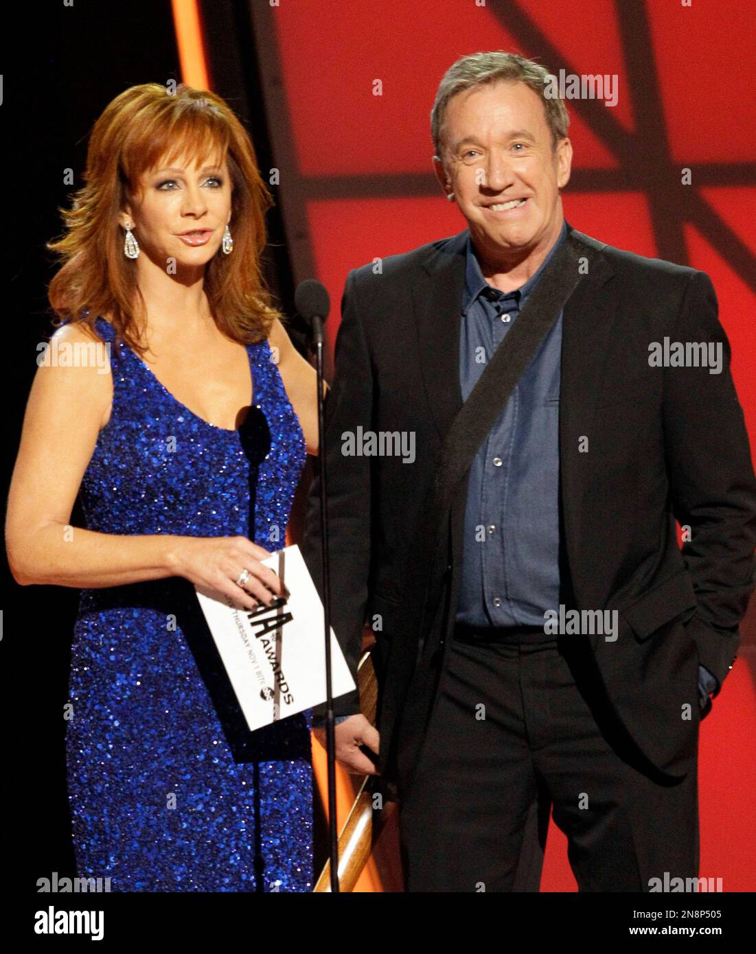 Reba McEntire, left, and Tim Allen present the award for entertainer of ...