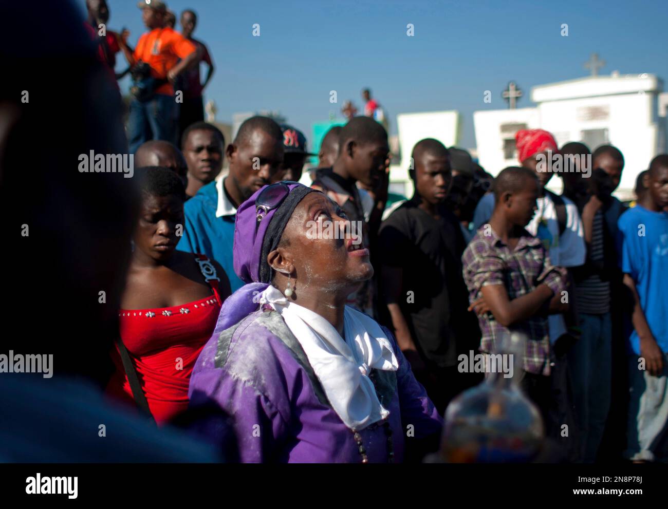 A Voodoo believer dressed as a Gede, or spirit, reacts during a Voodoo ...