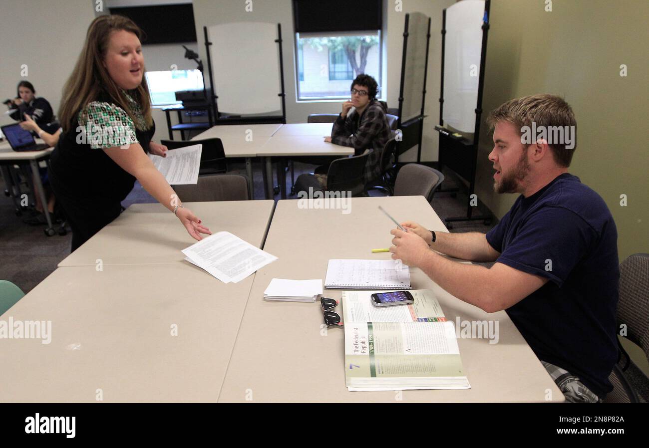 History professor Meredith Richards Martin, left, gives a handout to U ...