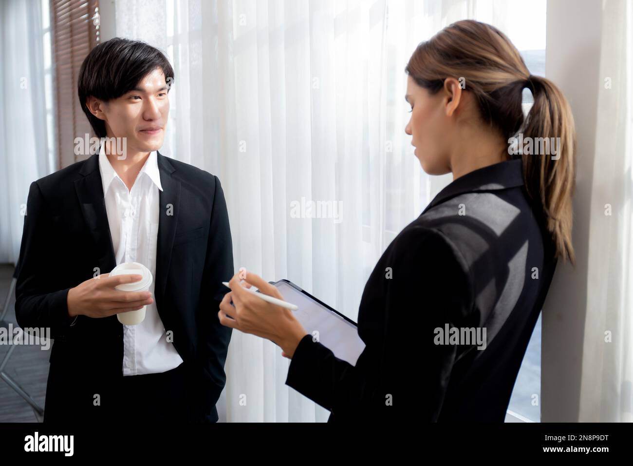 Young manager talking with secretary about report marketing on digital ...