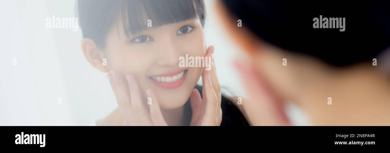 Beautiful face of young asian woman with happy smiling and touch cheek ...