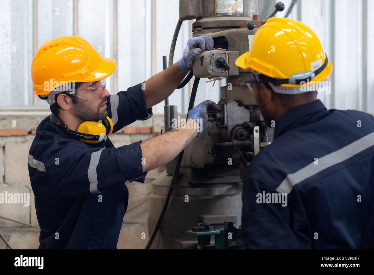 Engineer man training with foreman for apprentice using lathe ...