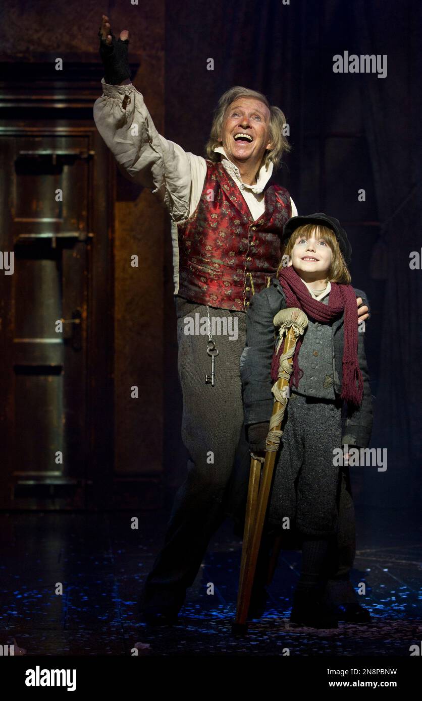 Tommy Steele as Ebenezer Scrooge, left and James Tobias-Norrington as ...