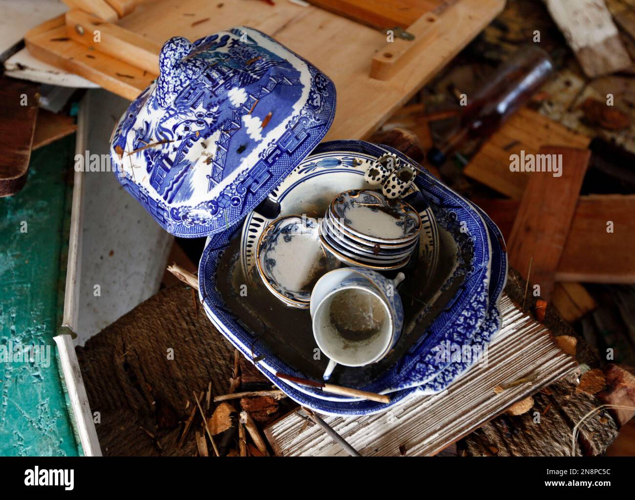 A bowl and cups from a china set are seen filled with water as items ...