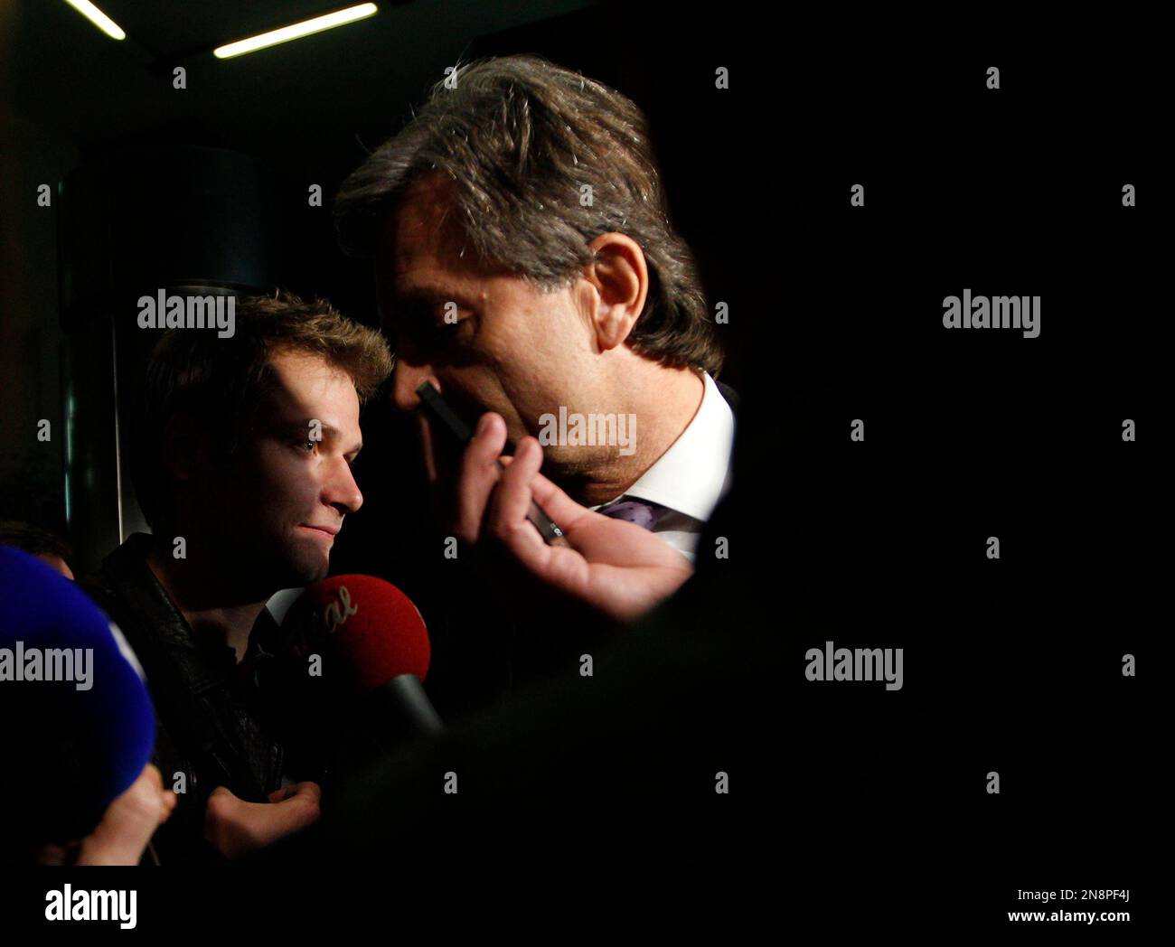 Italian race walker Alex Schwazer, left, leaves Coni headquarters with ...