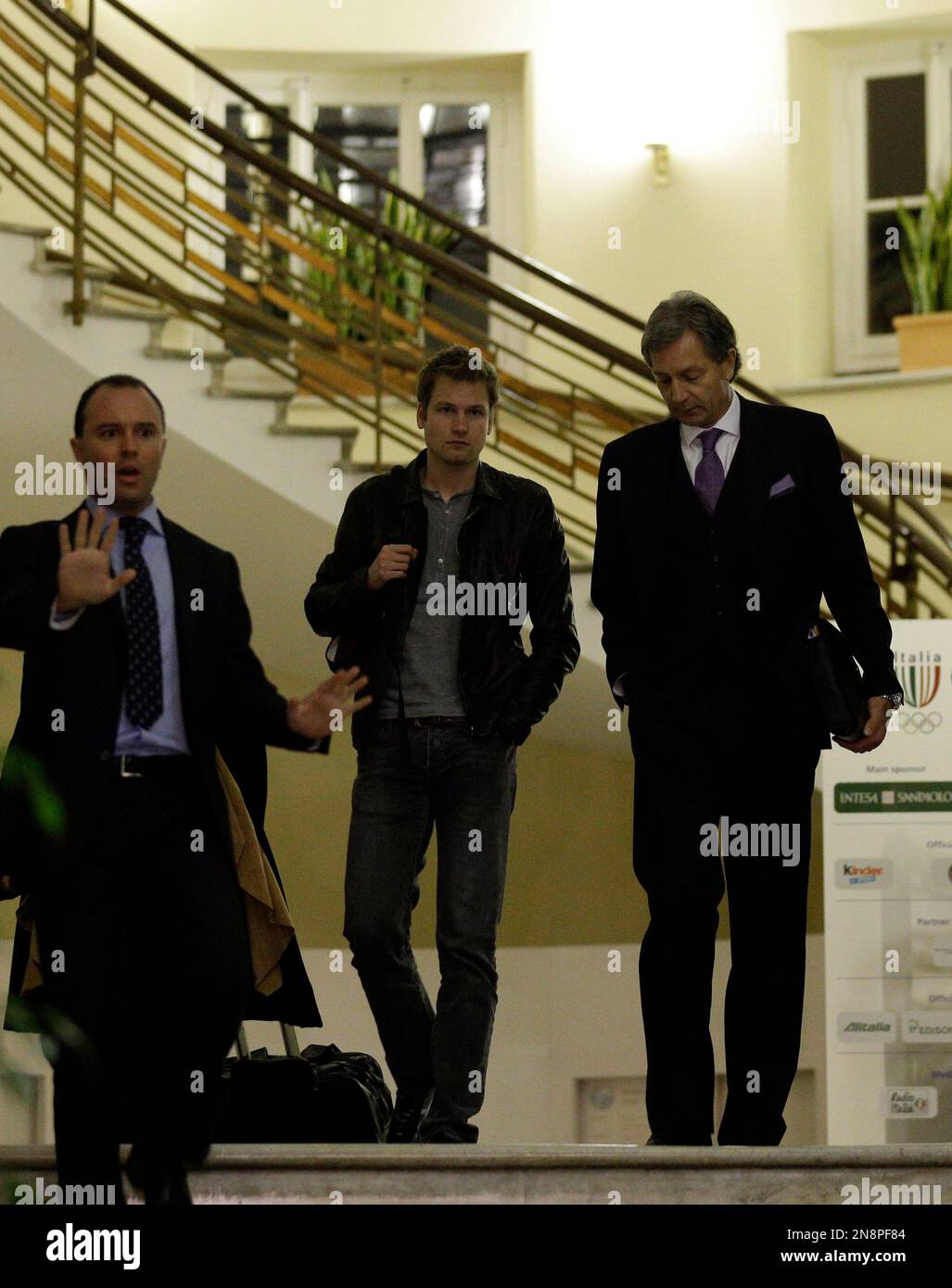 Italian race walker Alex Schwazer, center, leaves the Coni headquarters ...