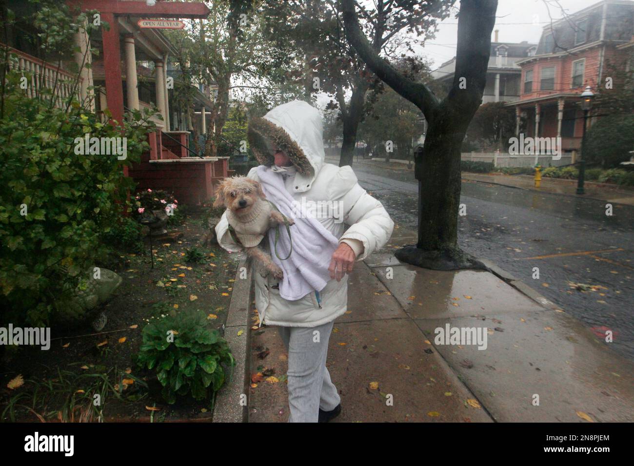Cape May resident Nancy Duvall gives up in a pouring rain after trying ...