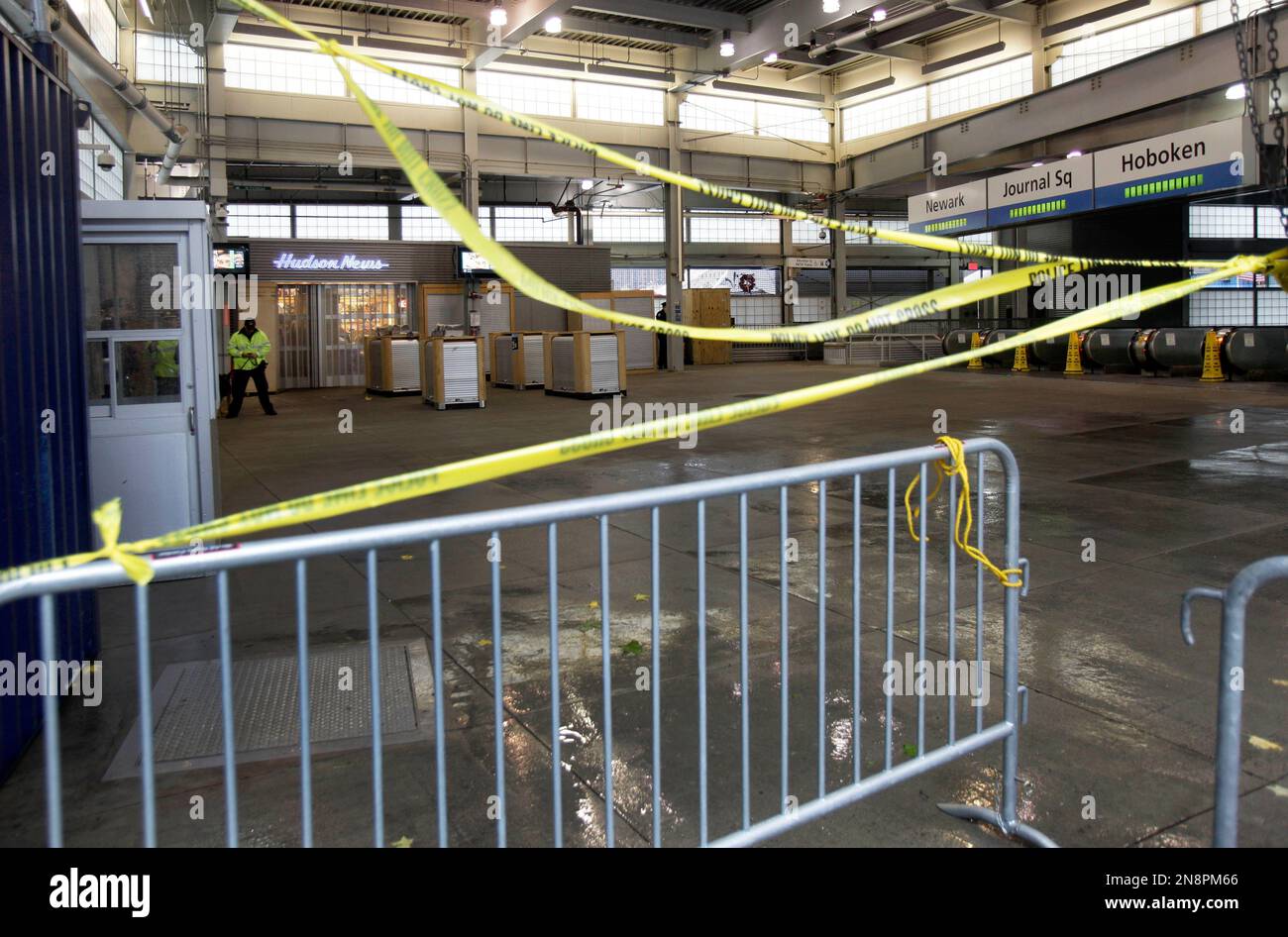 Barricades and caution tape cross an entrance to the closed PATH ...