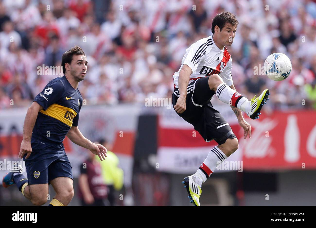 River Plate's Rodrigo Mora, right, controls the ball chased by Boca ...