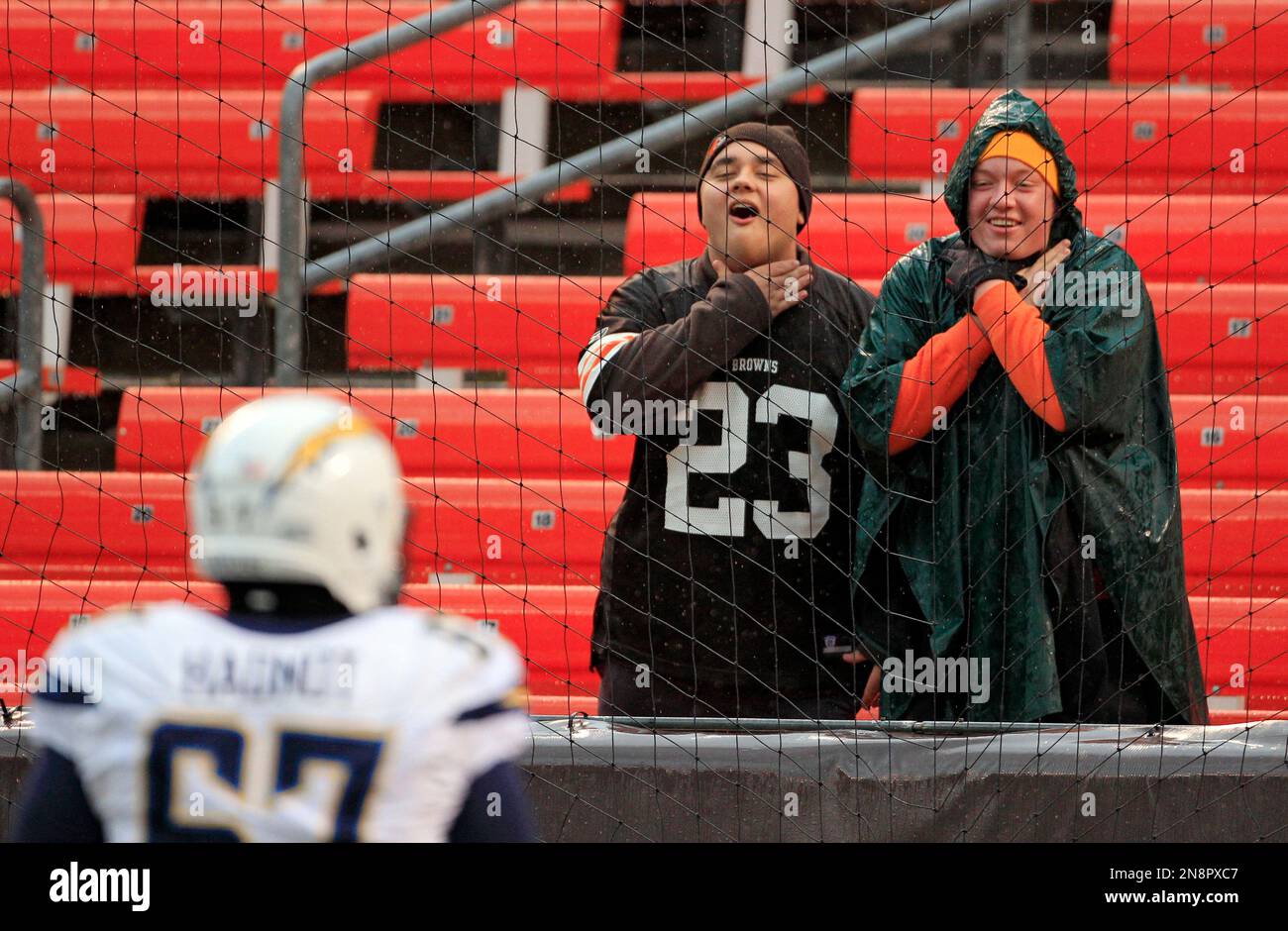 Two Cleveland Browns fans gesture toward San Diego Chargers center Rex ...