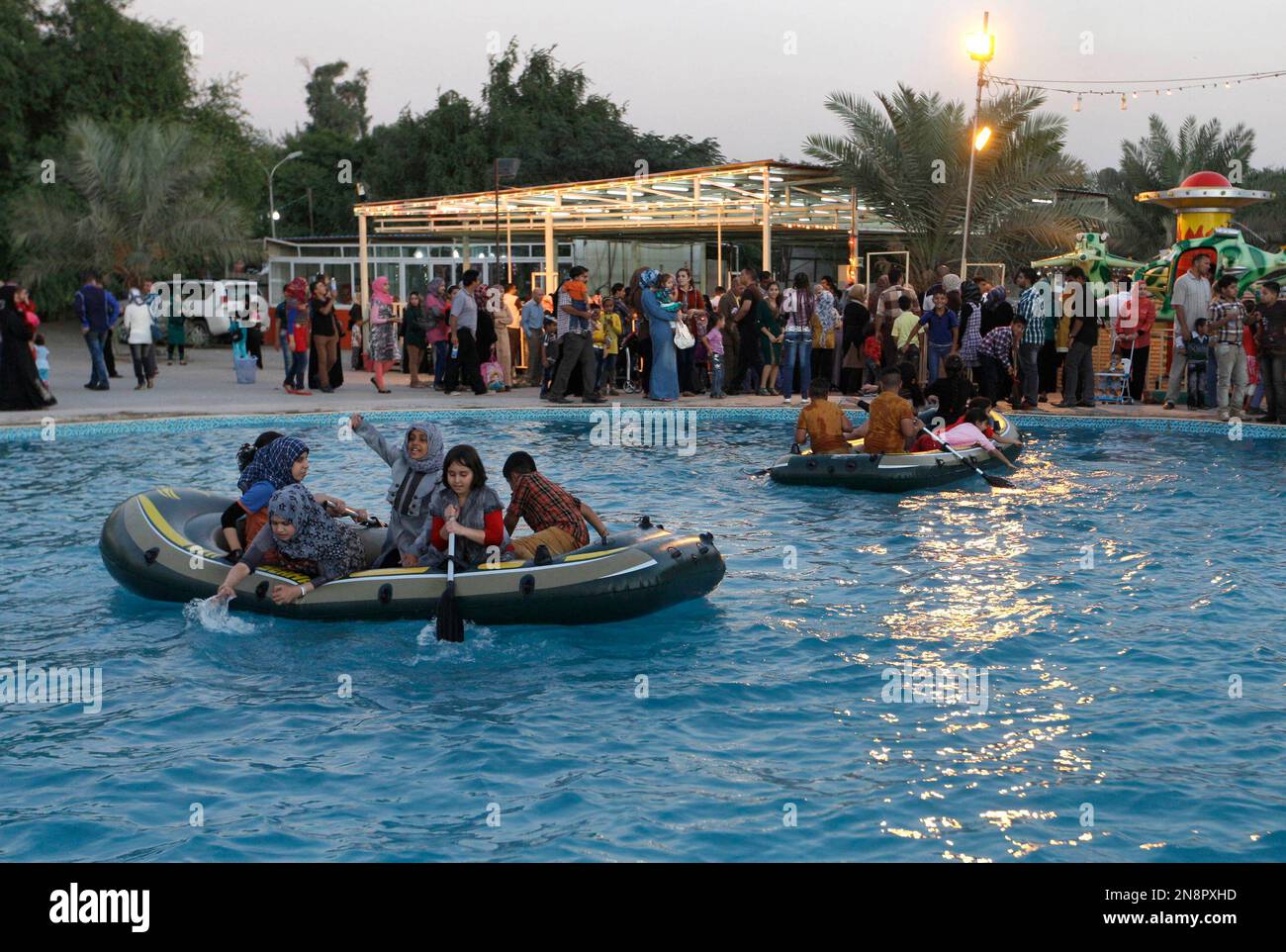 People celebrate during Eid al-Adha celebrations in Baghdad, Iraq ...