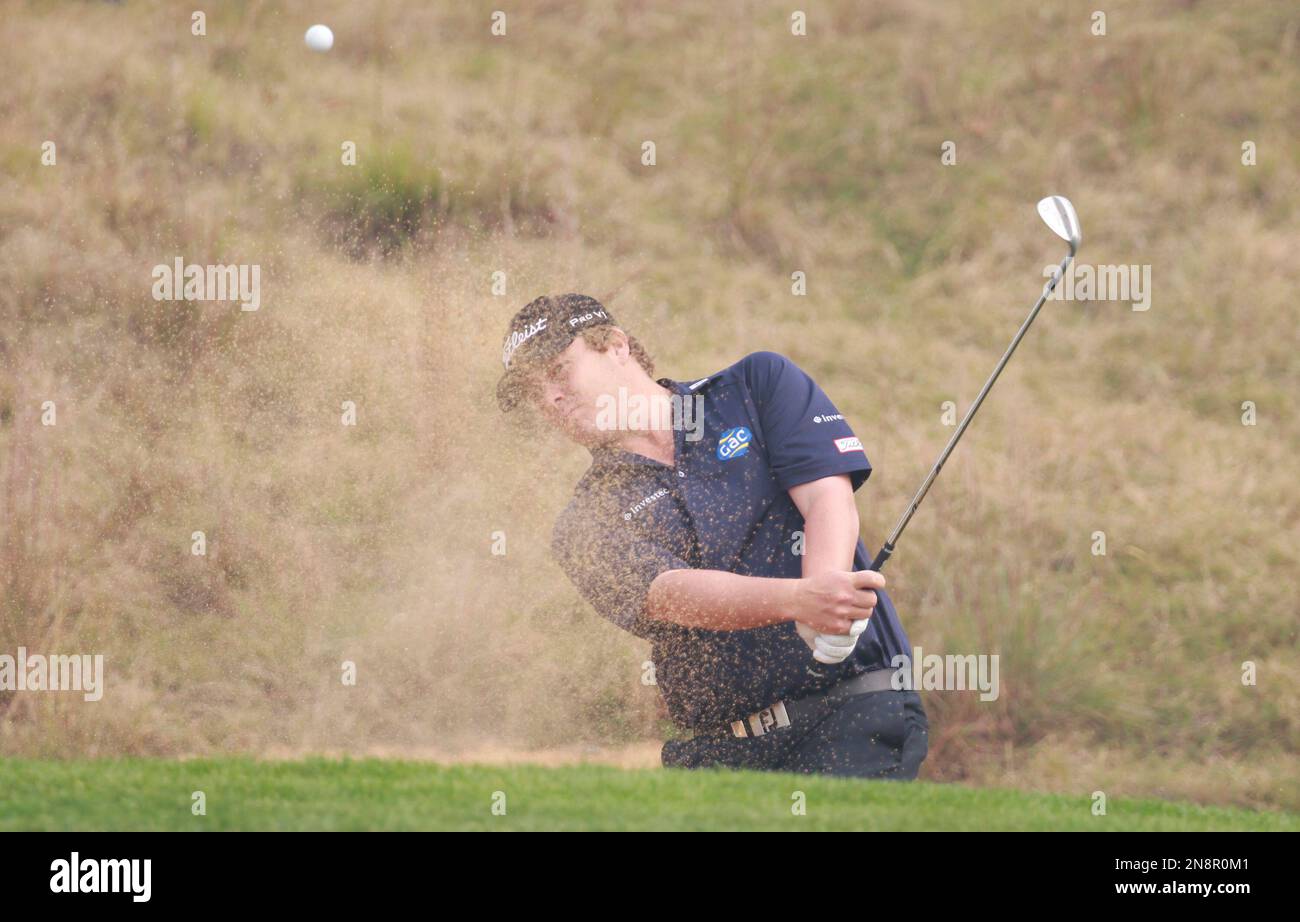 George Coetzee from South Africa hits out of a bunker on the 7th green ...