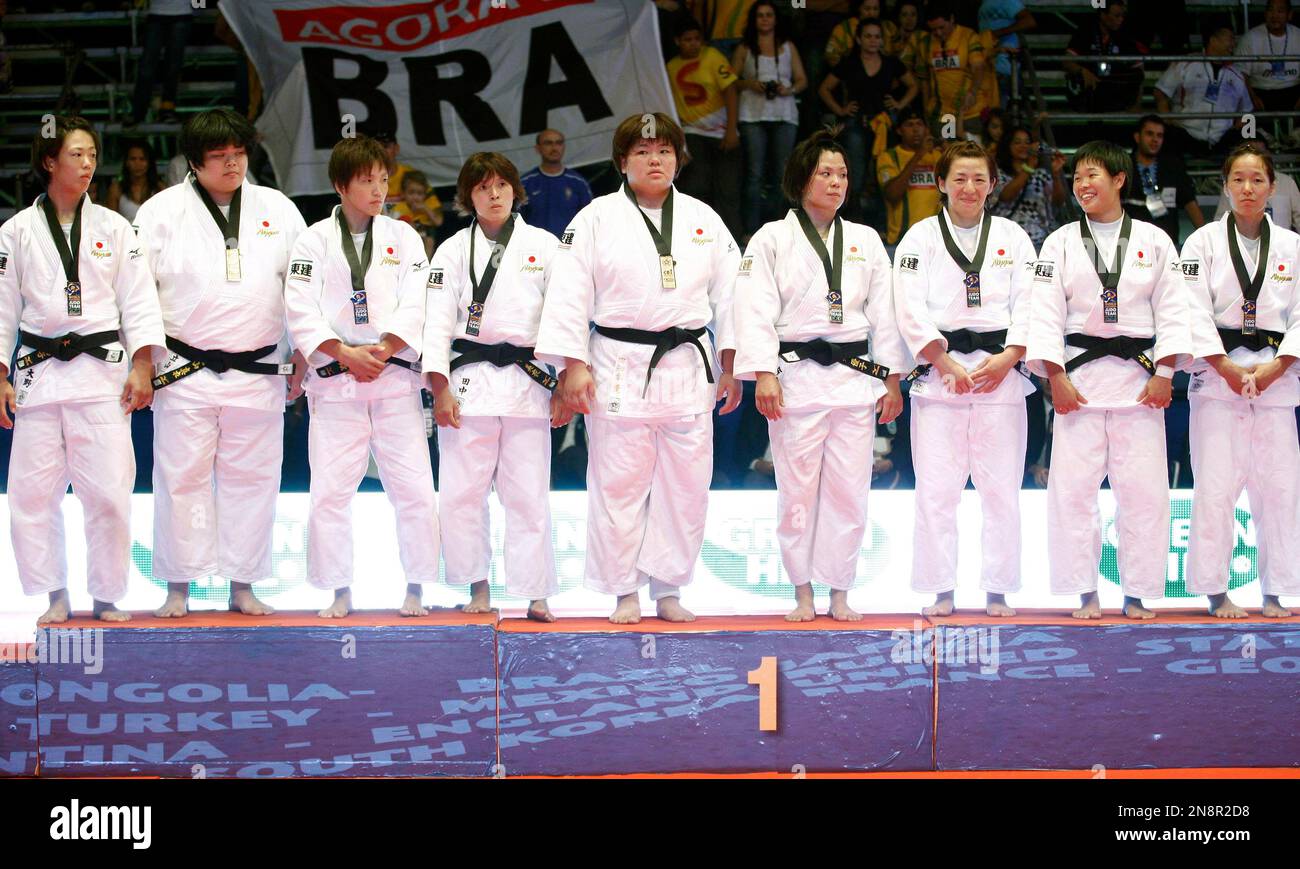 Japan's athletes stand at the podium after wining the gold medal in the ...