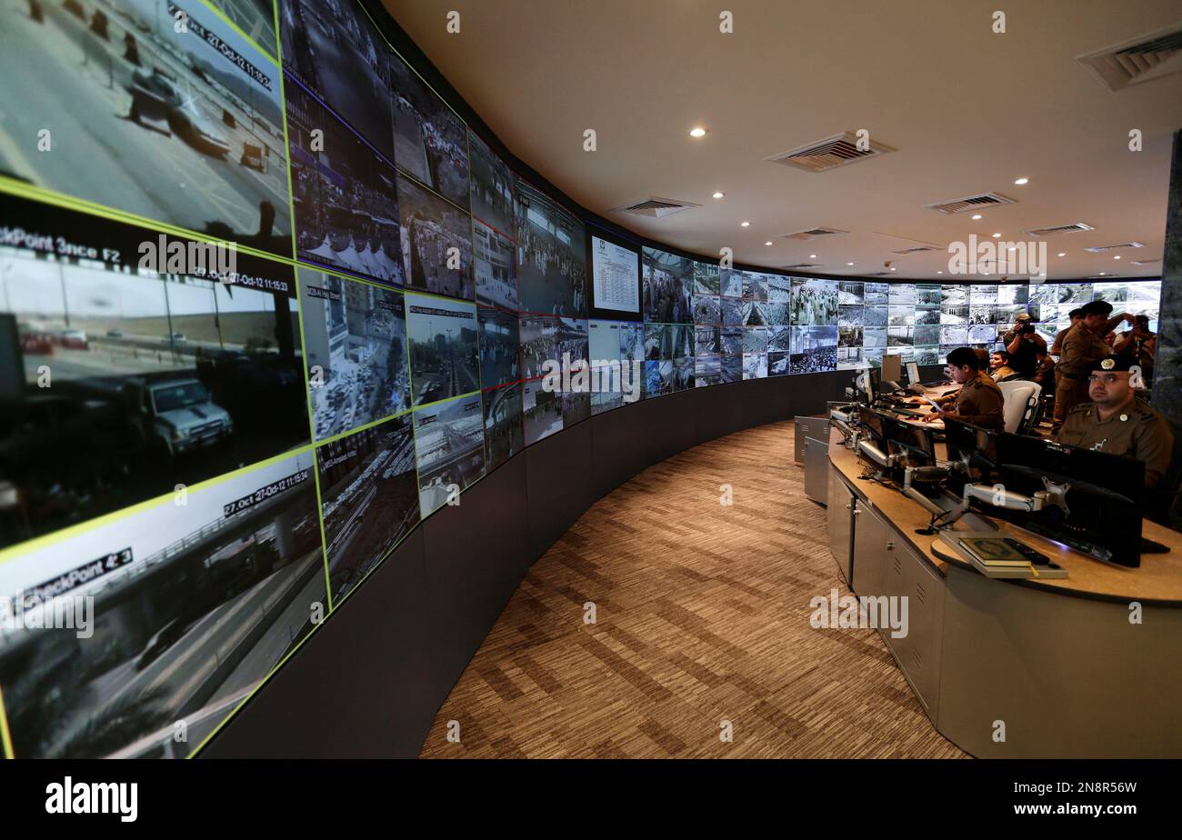 Saudi police officers monitor screens connected to cameras set up to ...
