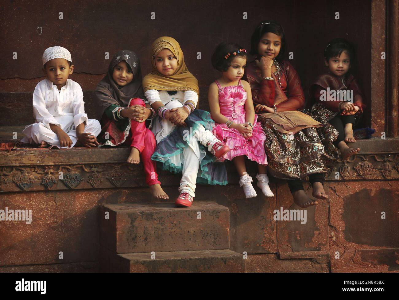 Indian Muslim children wear new clothes as they sit together during ...