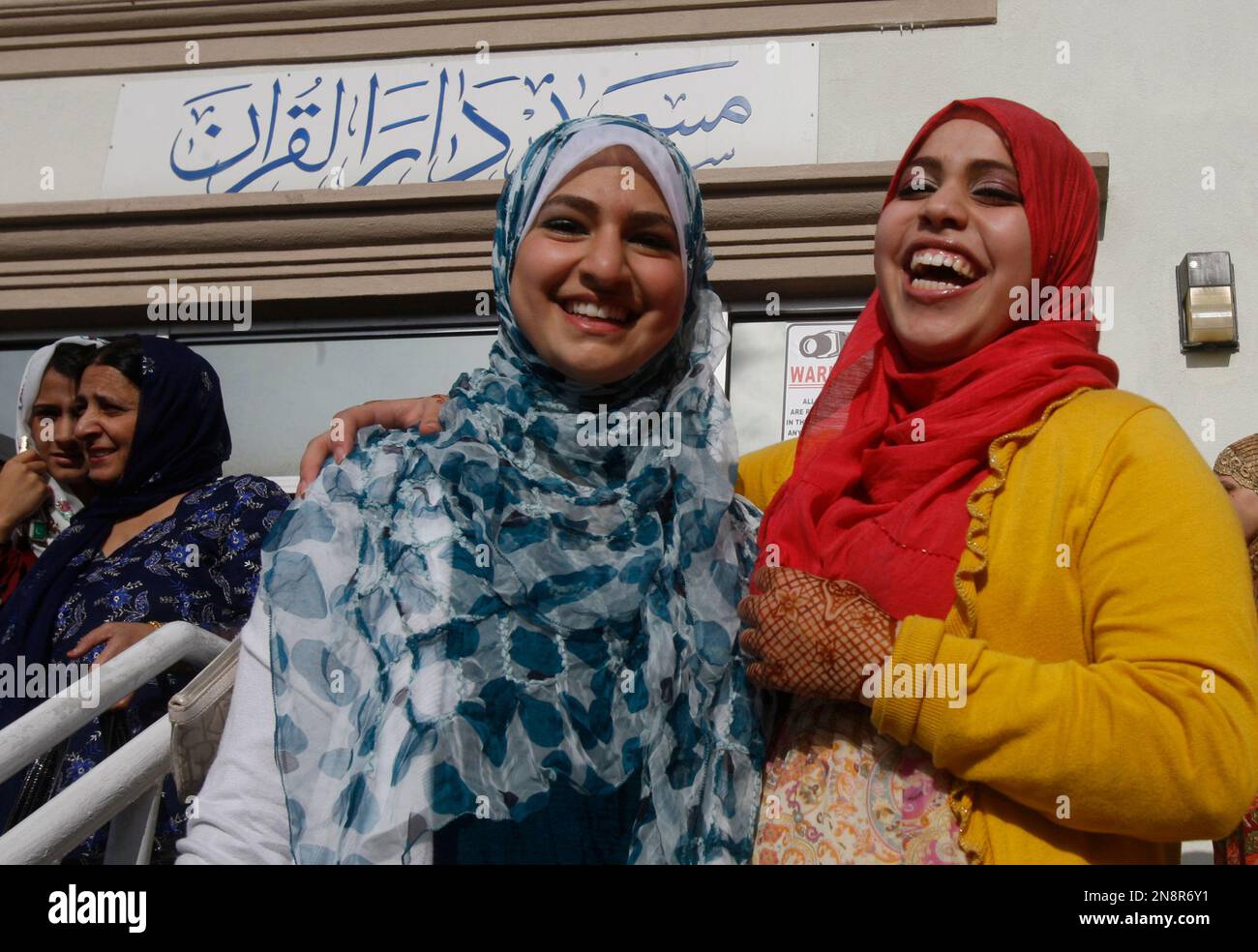 American Muslims smile as they exchange greetings after Eid prayers ...
