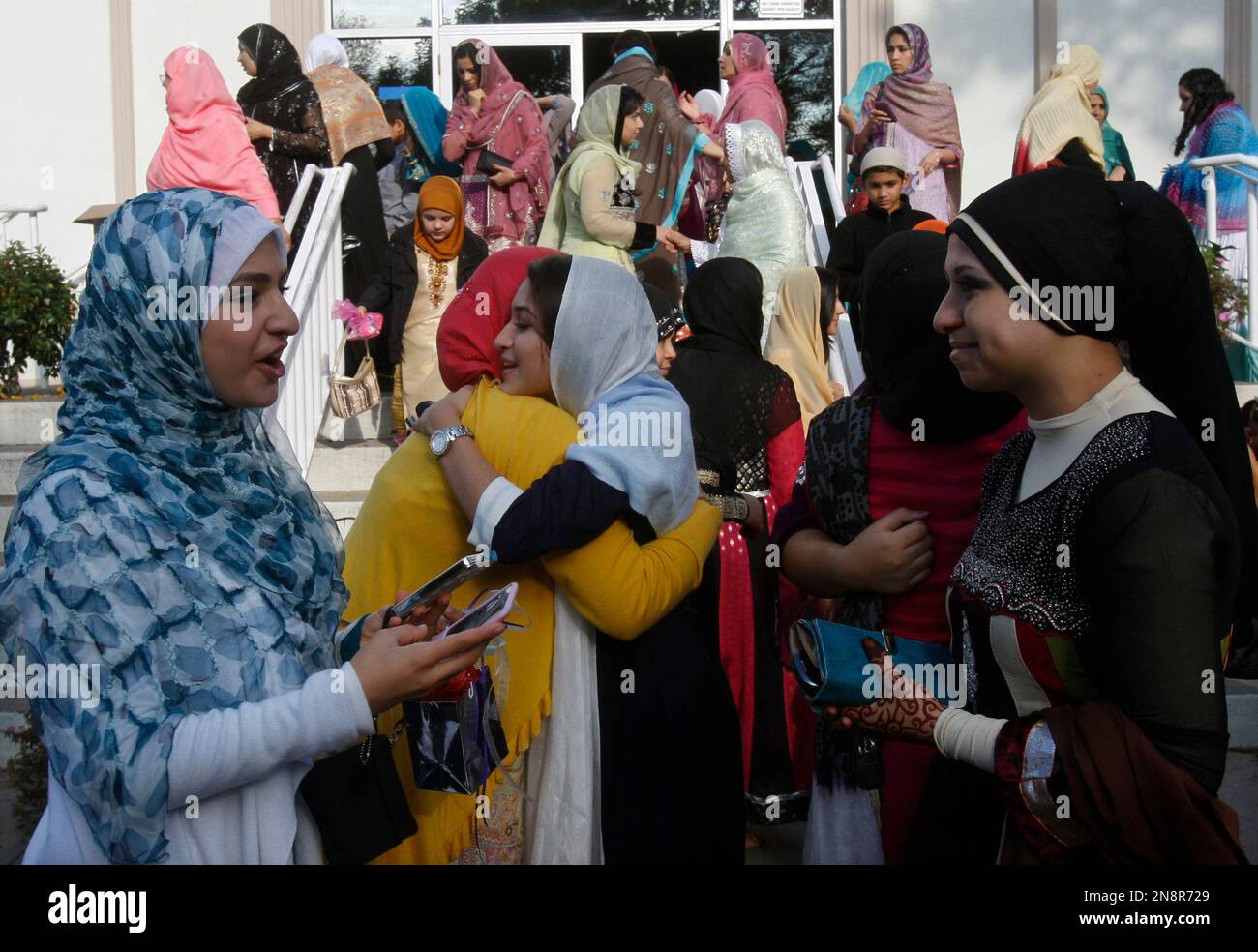American Muslims exchange greetings after Eid prayers outside Masjid ...
