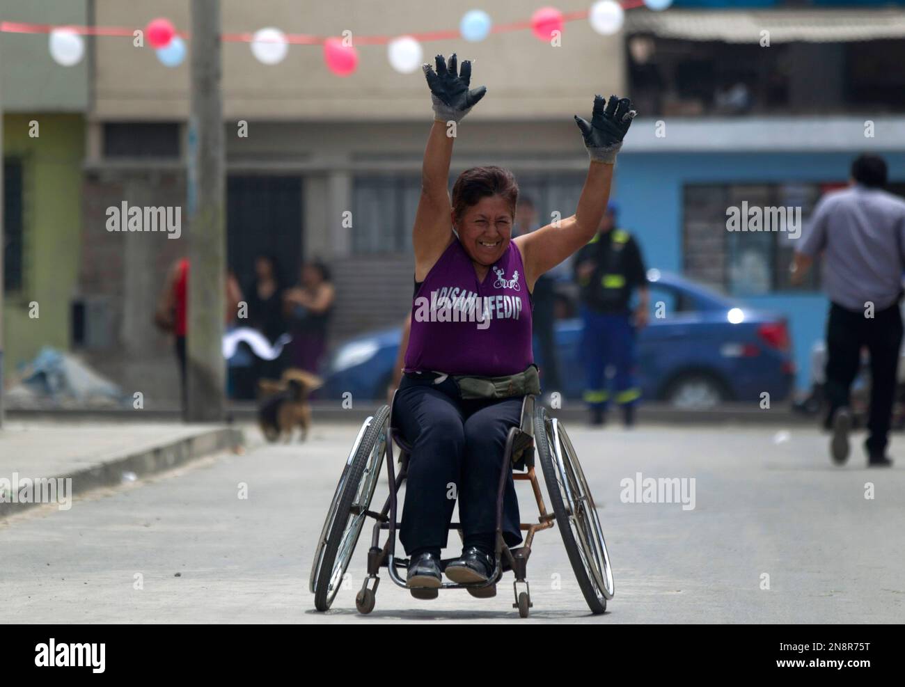Jovita Ore, 62, celebrates as she crosses the finish line during a one ...