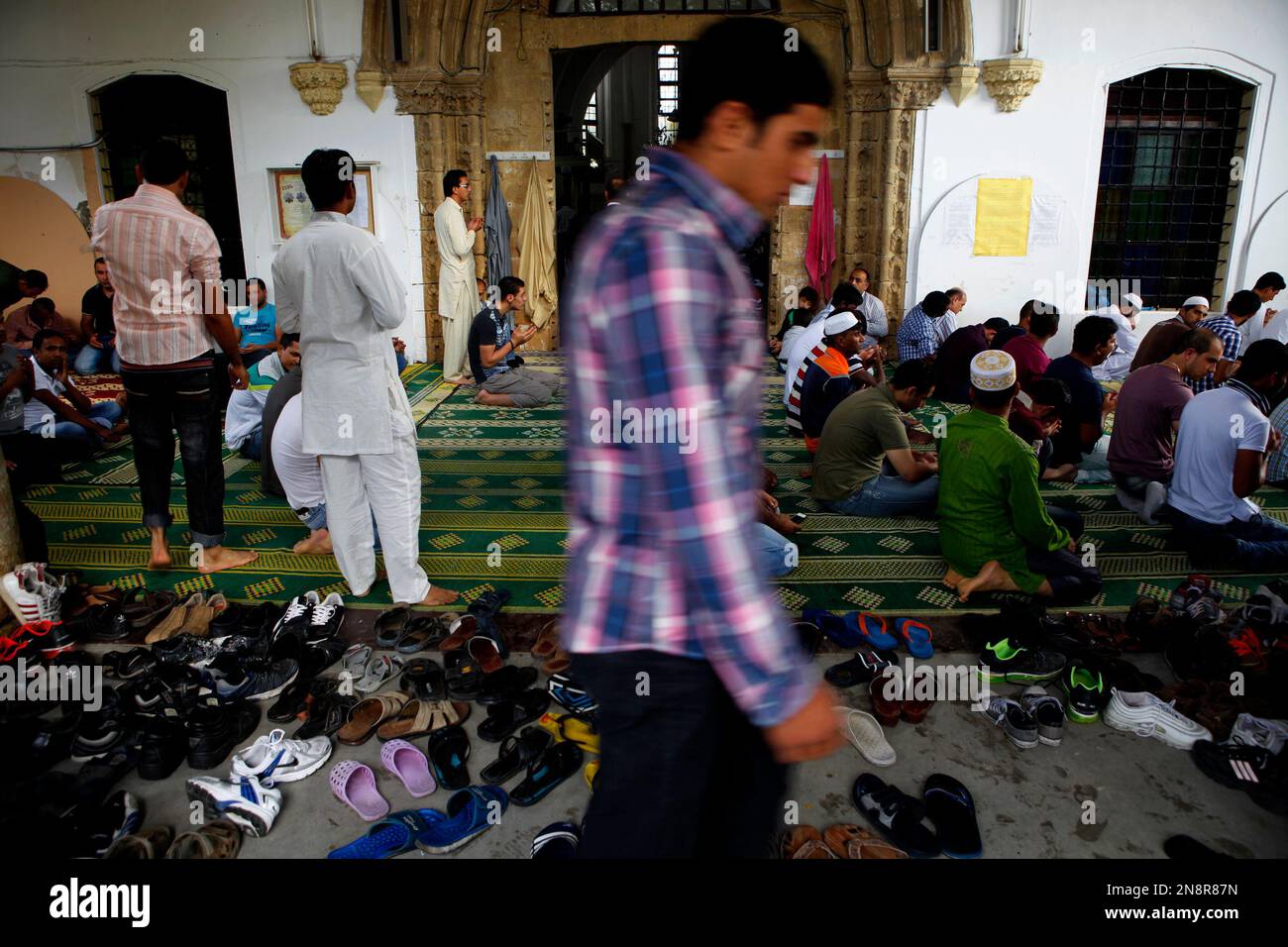 Muslim immigrants who lives in Cyprus pray in the Omeriye mosque, known ...
