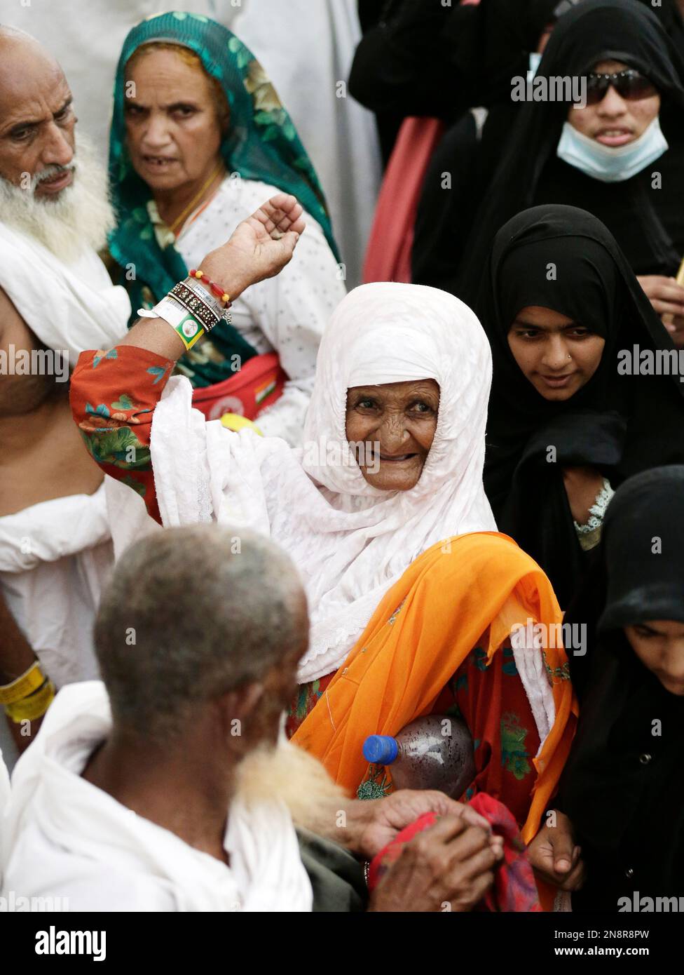 A Muslim pilgrim cast a stone at a pillar, symbolizing the stoning of ...