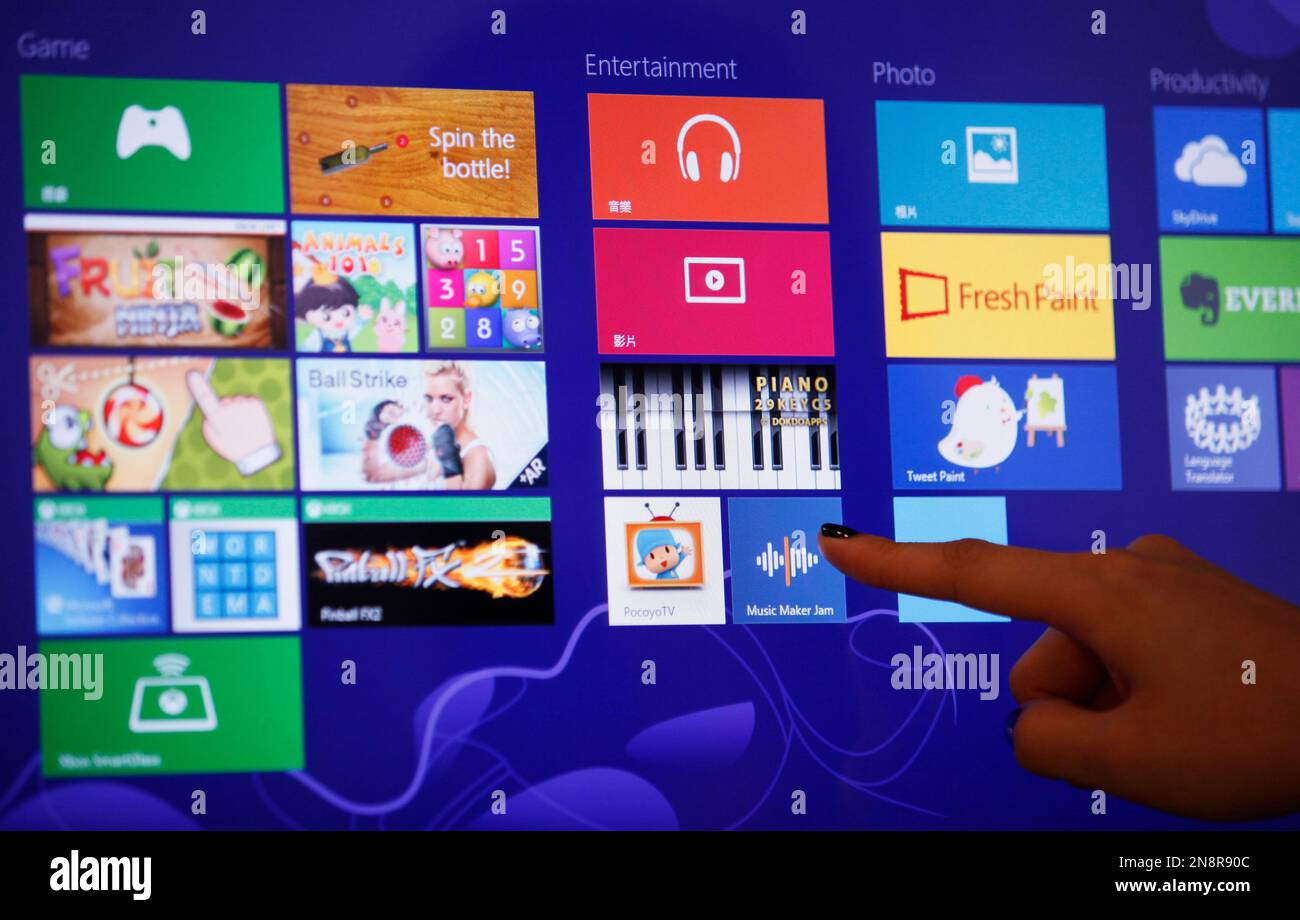 An attendant demonstrates the Microsoft Windows 8 operating system ...