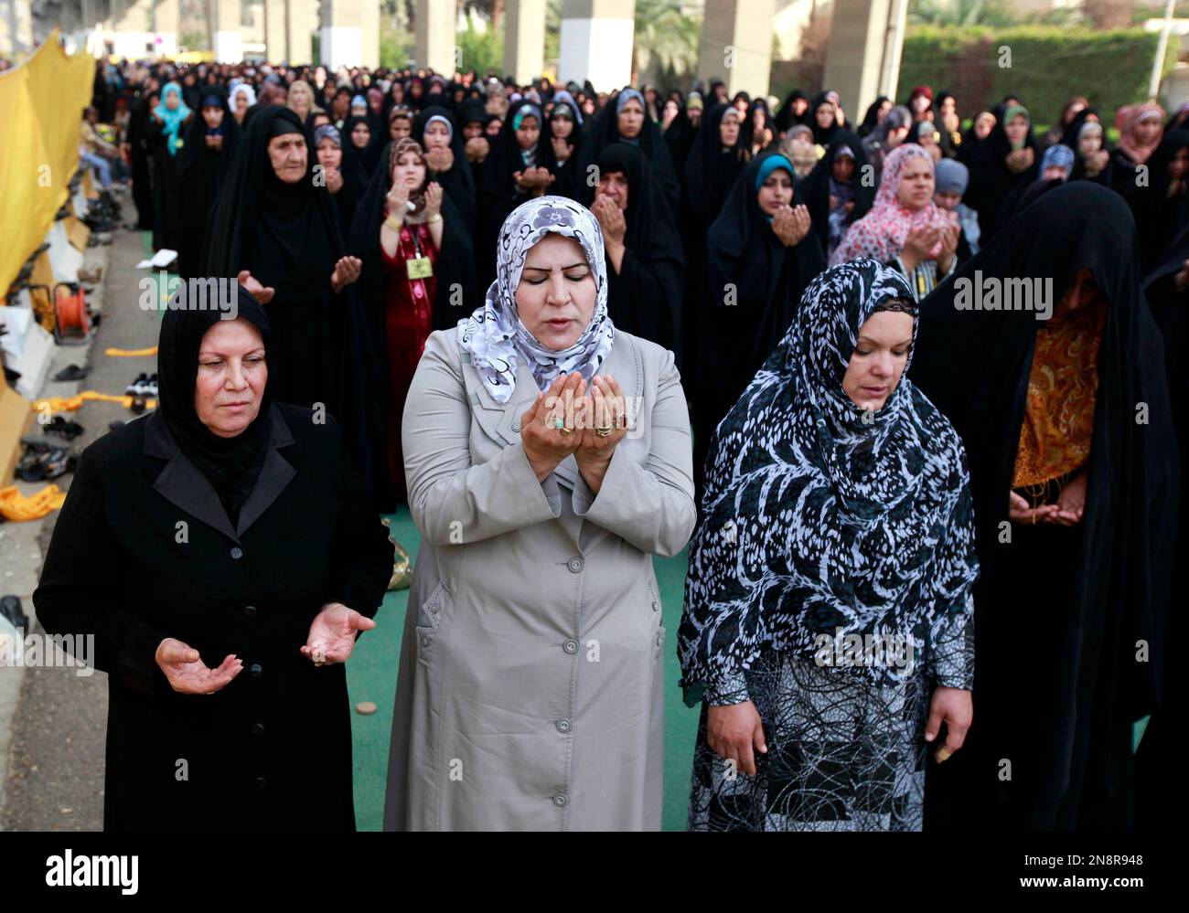 Iraqi Shiite Muslim women attend the Eid al-Adha prayer, outside the ...